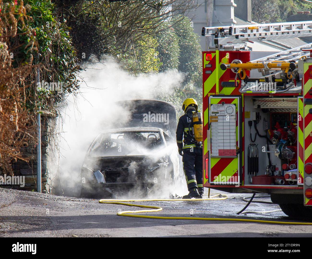 Fire Brigade Ireland putting out car fire Stock Photo - Alamy
