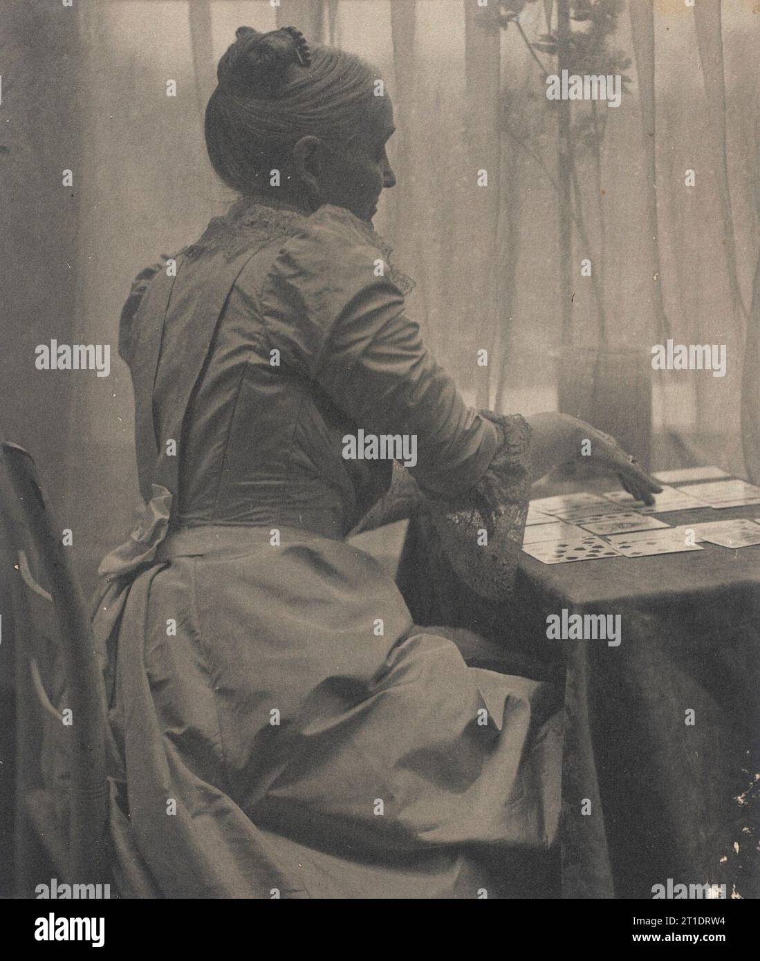 Woman playing solitaire card game hi-res stock photography and images ...