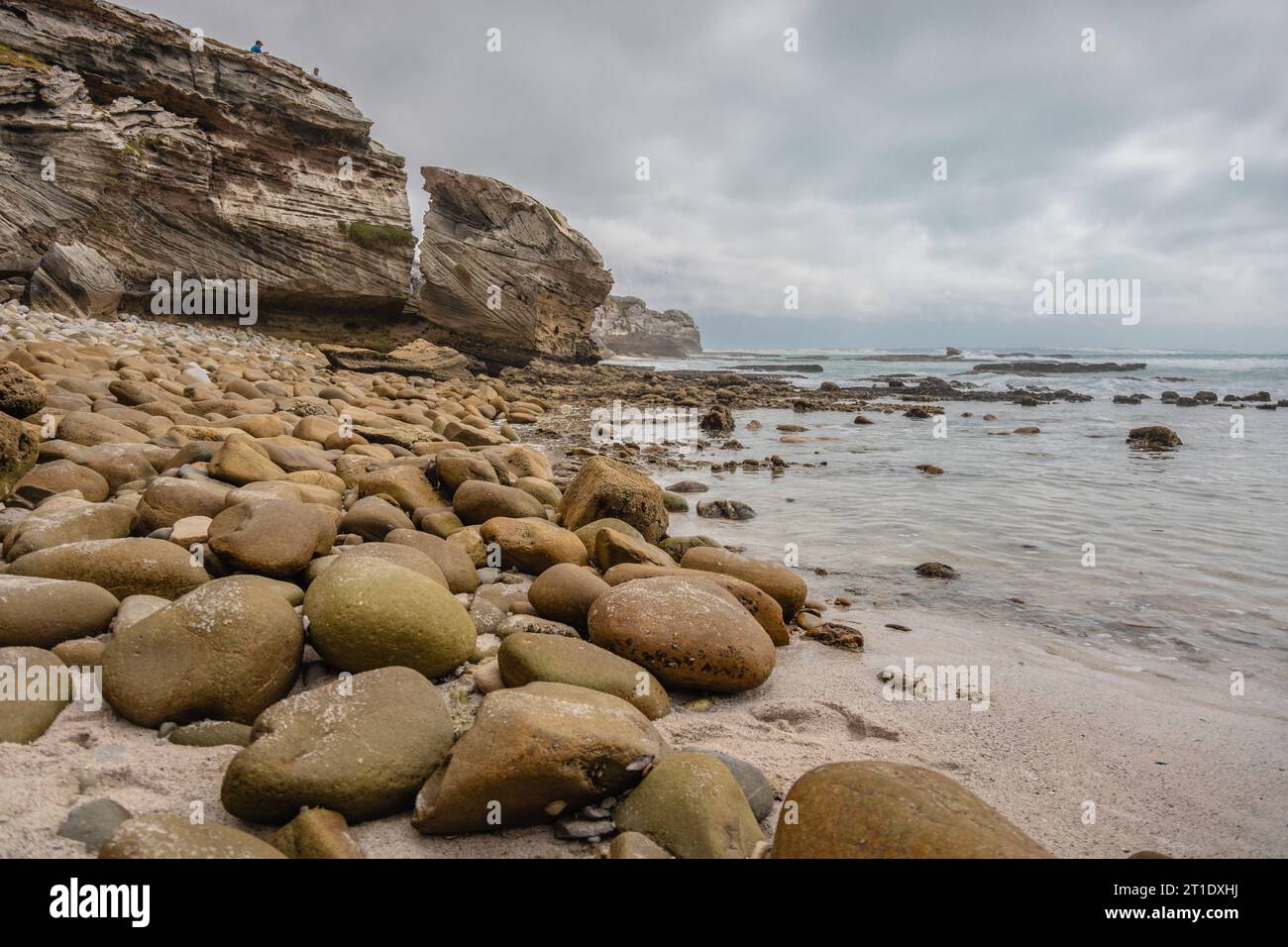 Captured from a low angle, the image showcases a rugged rocky beach ...