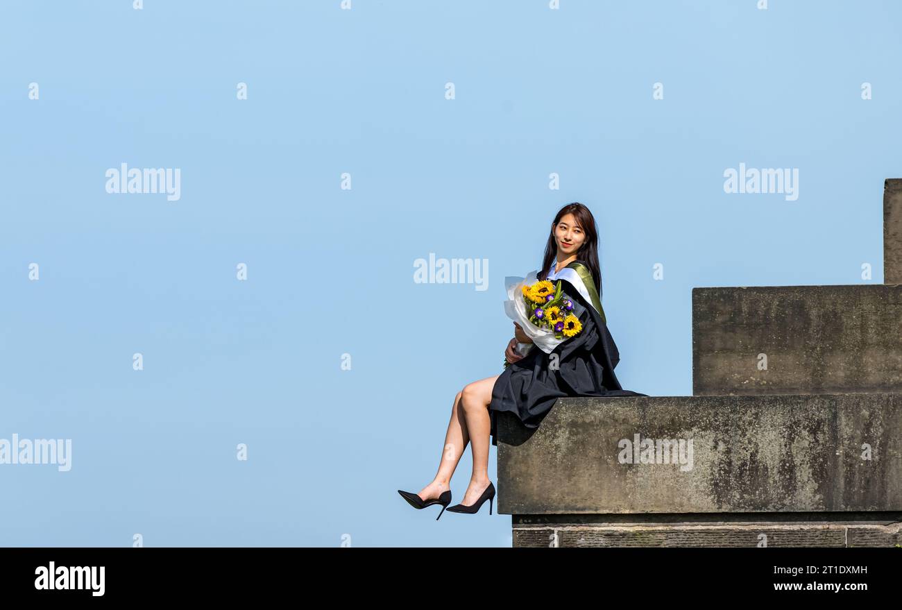 Asian student posing for photo to celebrate graduation, National ...