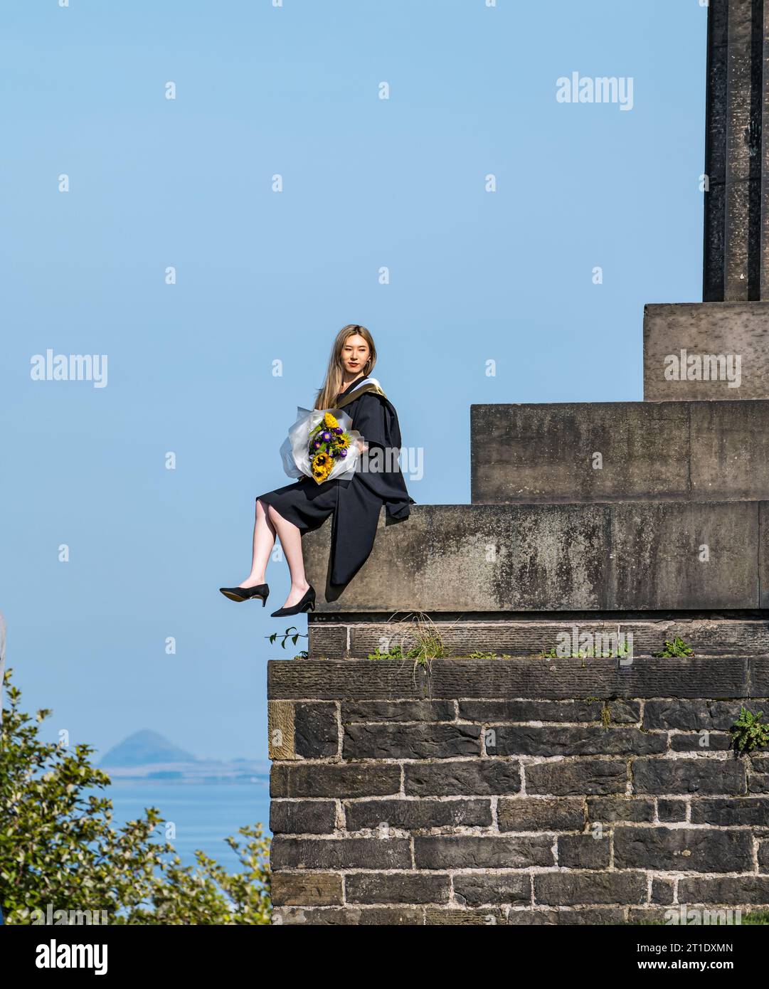Asian student posing for photo to celebrate graduation, National ...