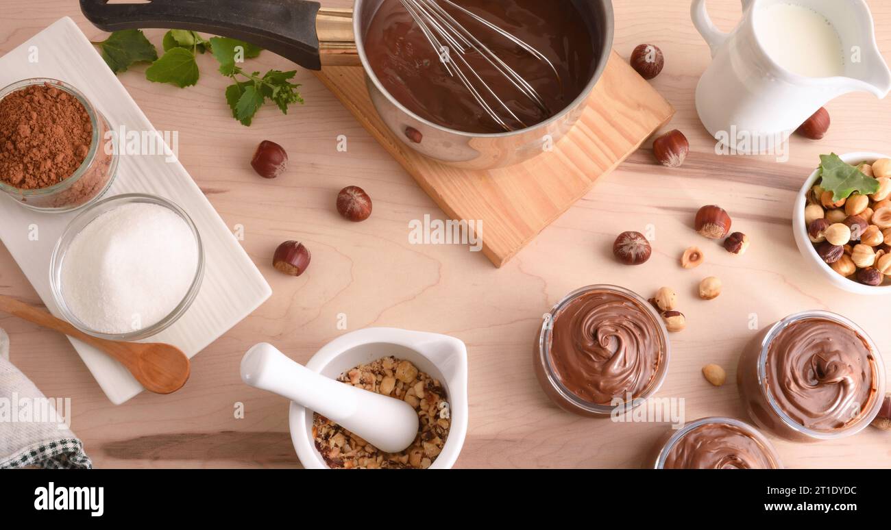 Table full of ingredients prepared in bowls to make homemade hazelnut ...