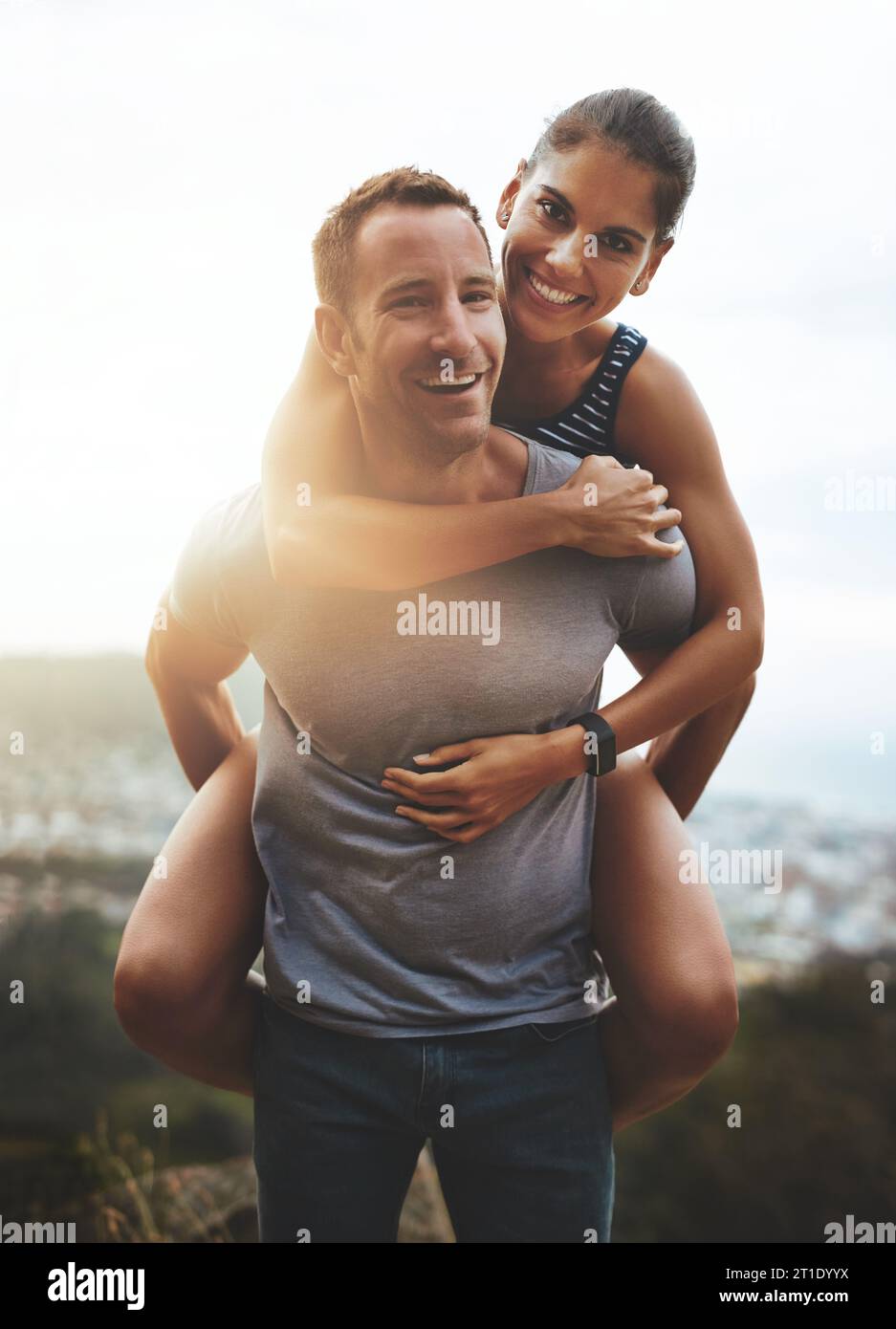 Portrait, piggy back and couple with love, outdoor and lens flare with ...