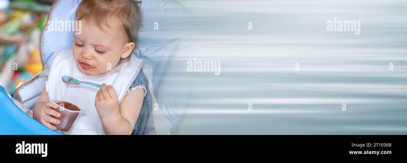 Cute baby girl eating tasty food and learning using spoon; panoramic ...