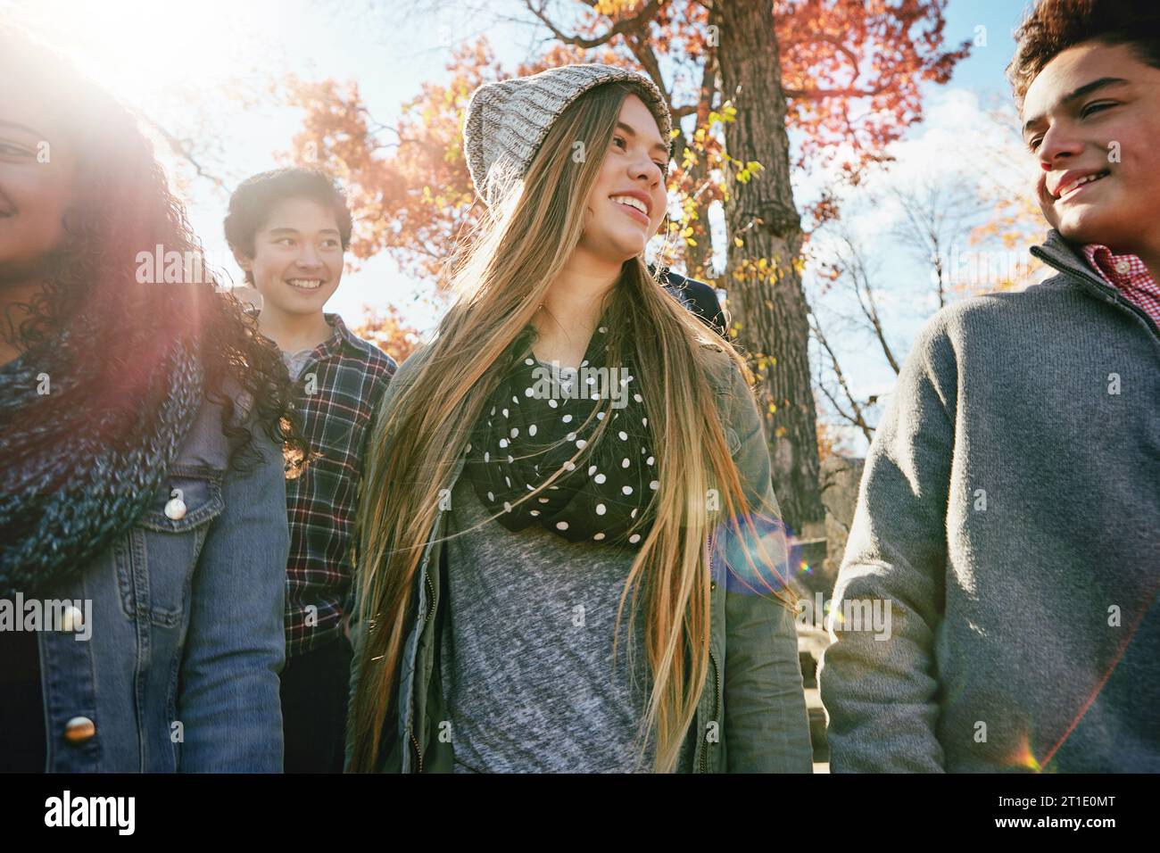 Teenager, walking and talking with friends in park, nature or social ...