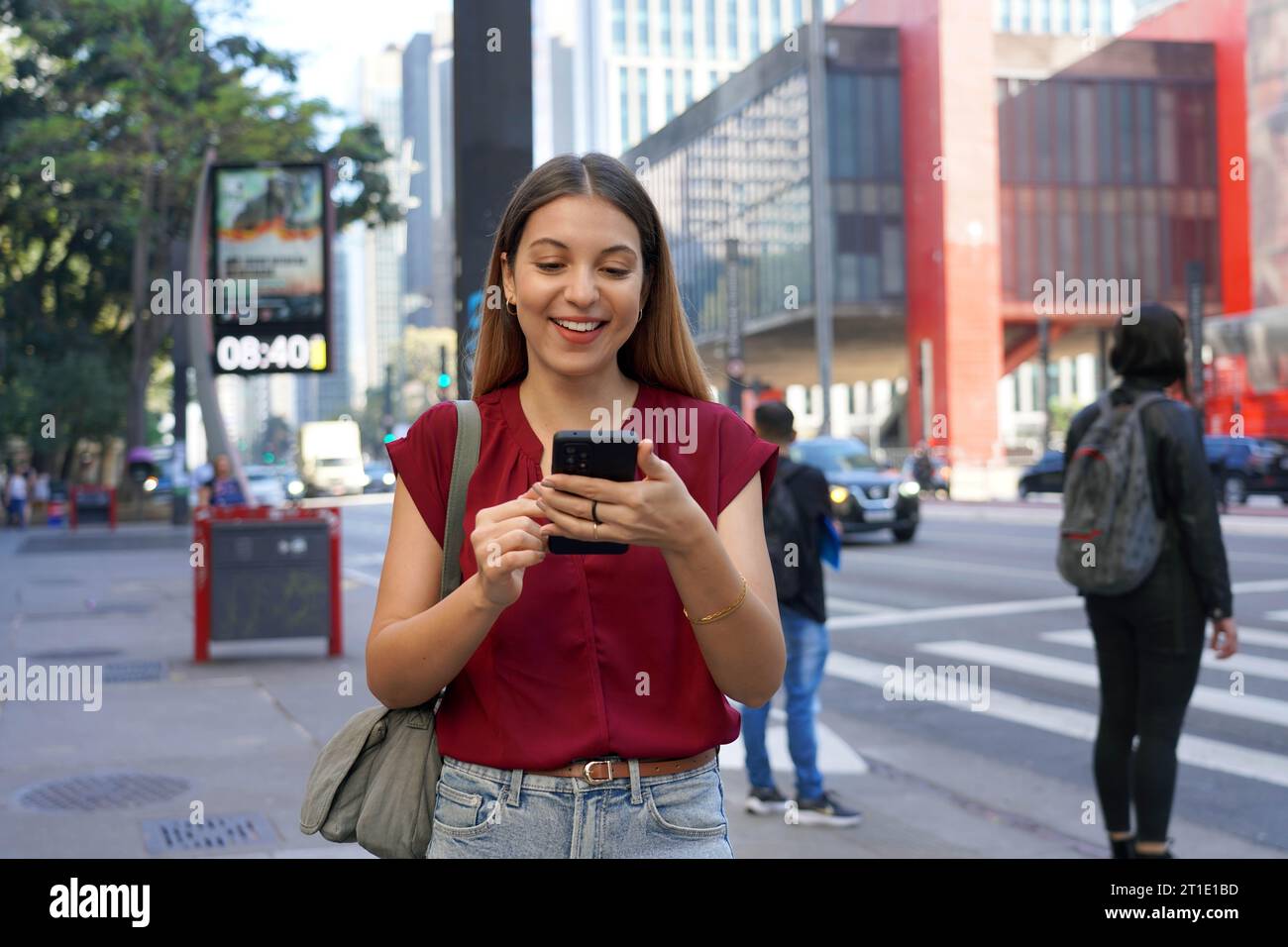Brazilian girl using mobile phone with blurred background on Paulista ...