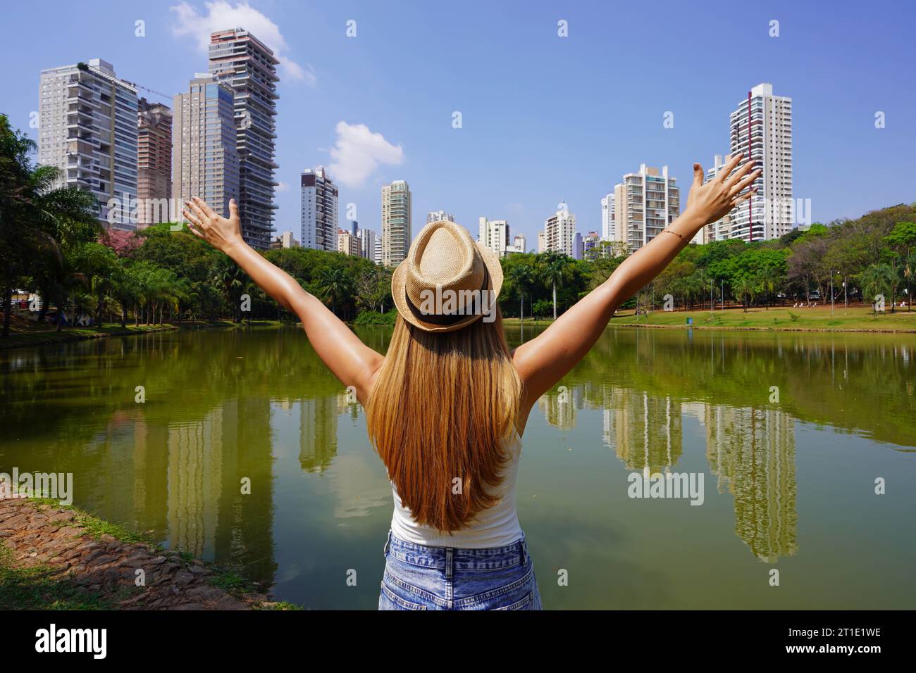 Travel in Goiania, Brazil. Back view of girl with raising arms in the ...