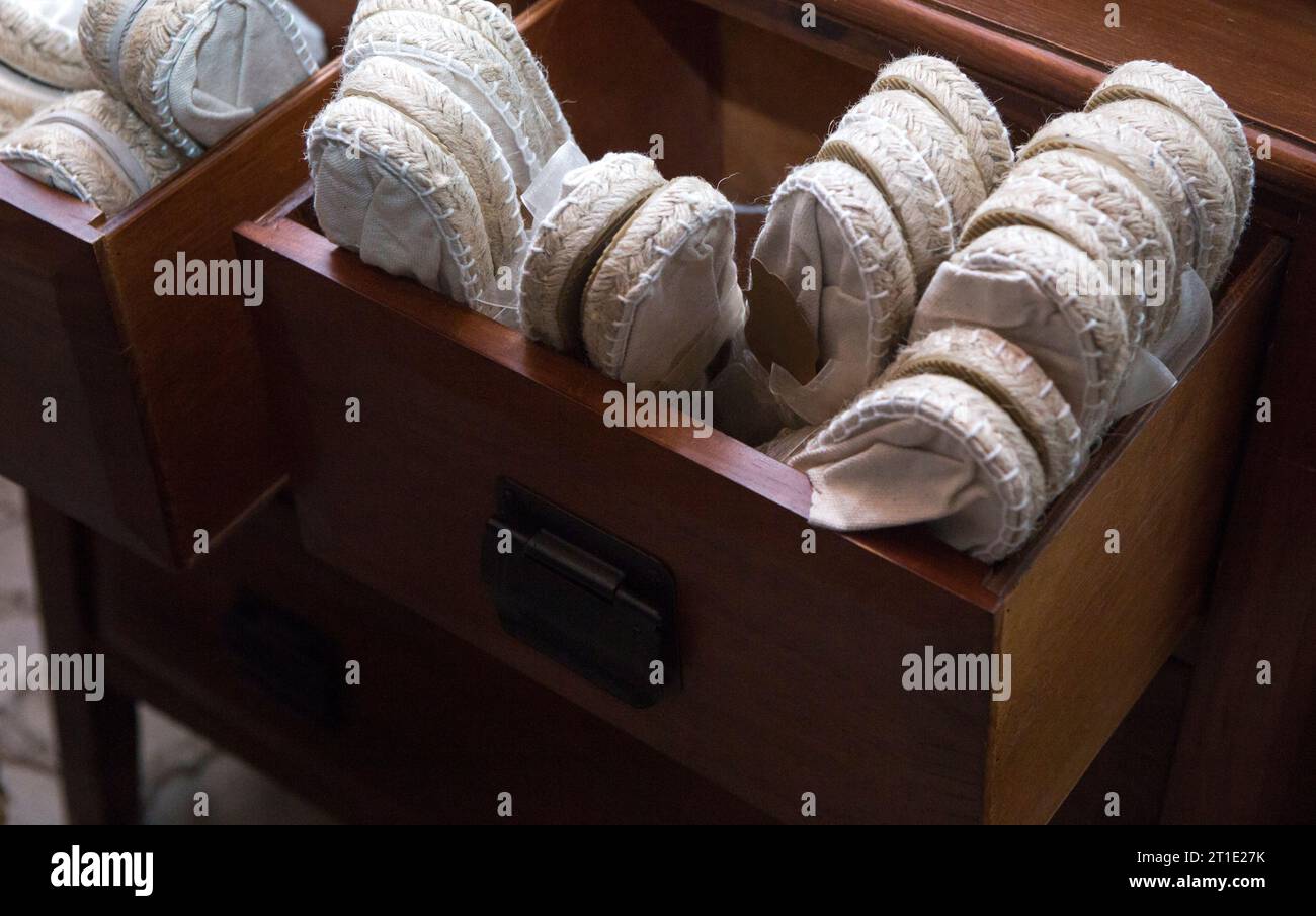 Wooden drawer full of white espadrille shoes. Disposable shoes for ...