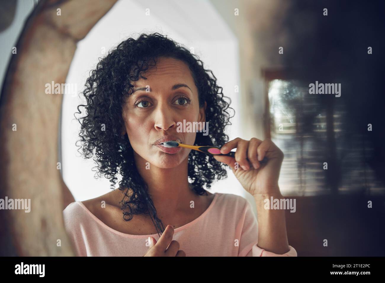 Woman, cleaning and brushing teeth in mirror, routine and oral hygiene ...