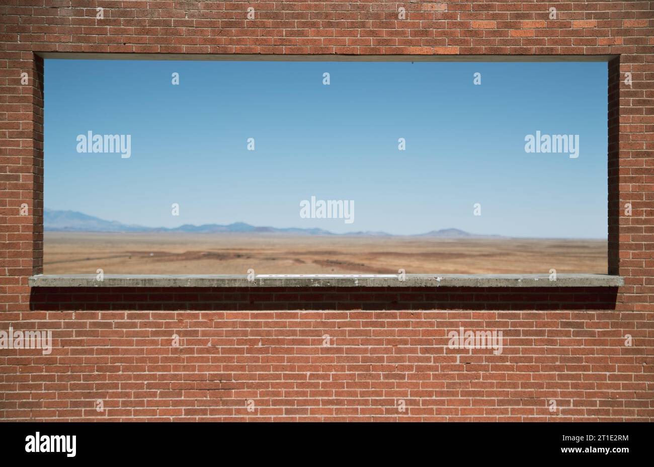 Arizona landscape behind a red brick wall Stock Photo - Alamy
