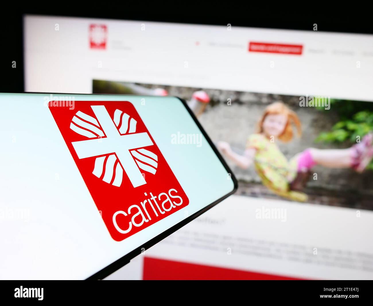 Smartphone with logo of German organization Deutscher Caritasverband e ...