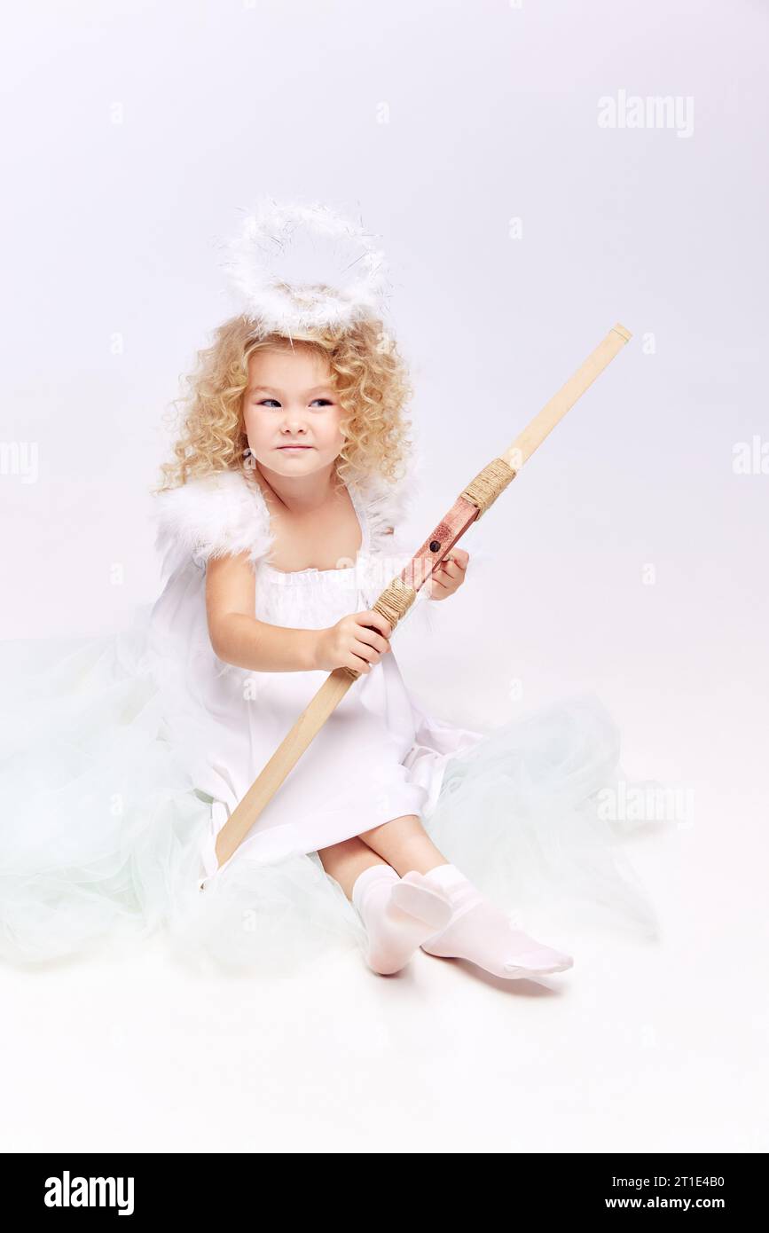 Little baby cupid, beautiful girl in image of angel holding bow ...