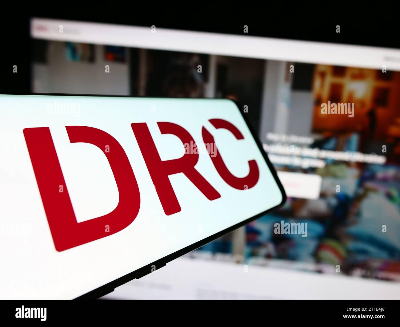 Cellphone with logo of humanitarian organization Danish Refugee Council ...