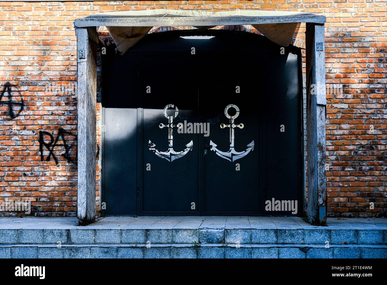 A close-up shot of an entrance to a building, framed by two large ...