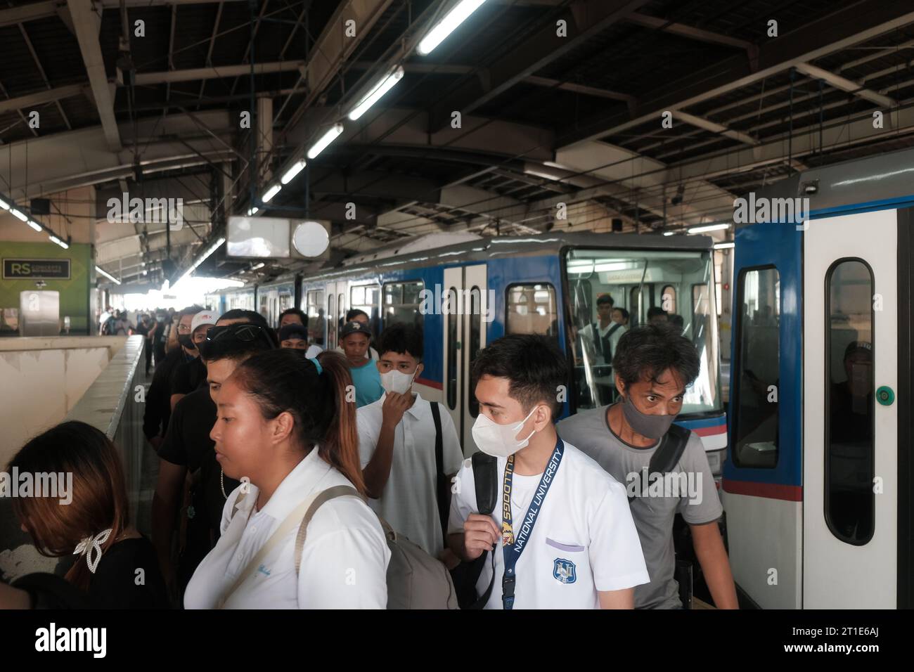 Filipino Commuters Exit The Train At An Lrt Line 1 Metro Station