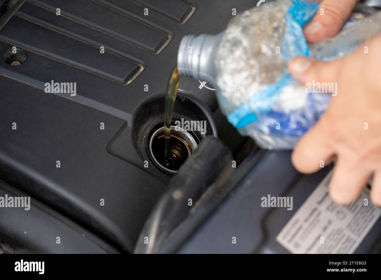 Pouring motor oil in a car Stock Photo - Alamy