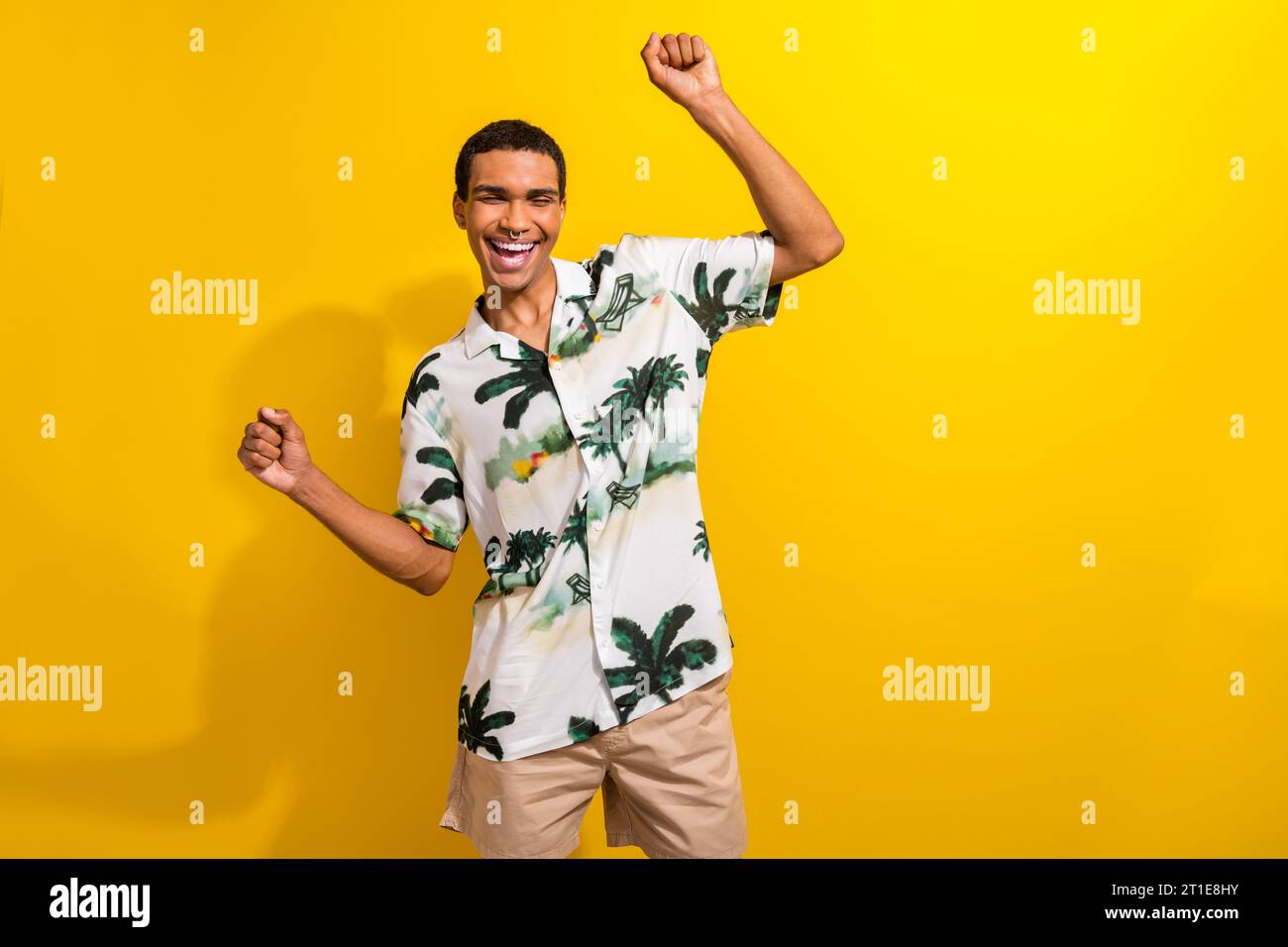 Portrait of overjoyed crazy guy wear print clothes with ring in nose ...