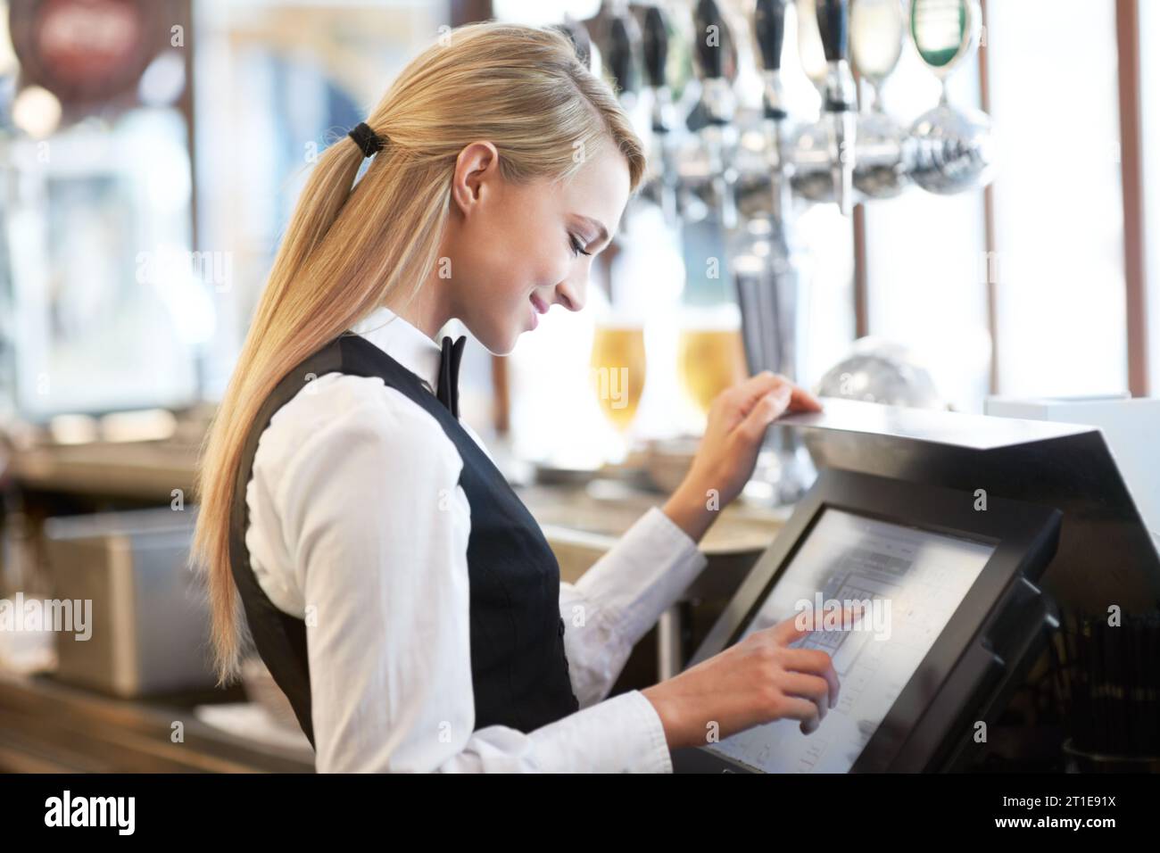 Cashier, barista and young woman waitress in cafe checking for payment ...