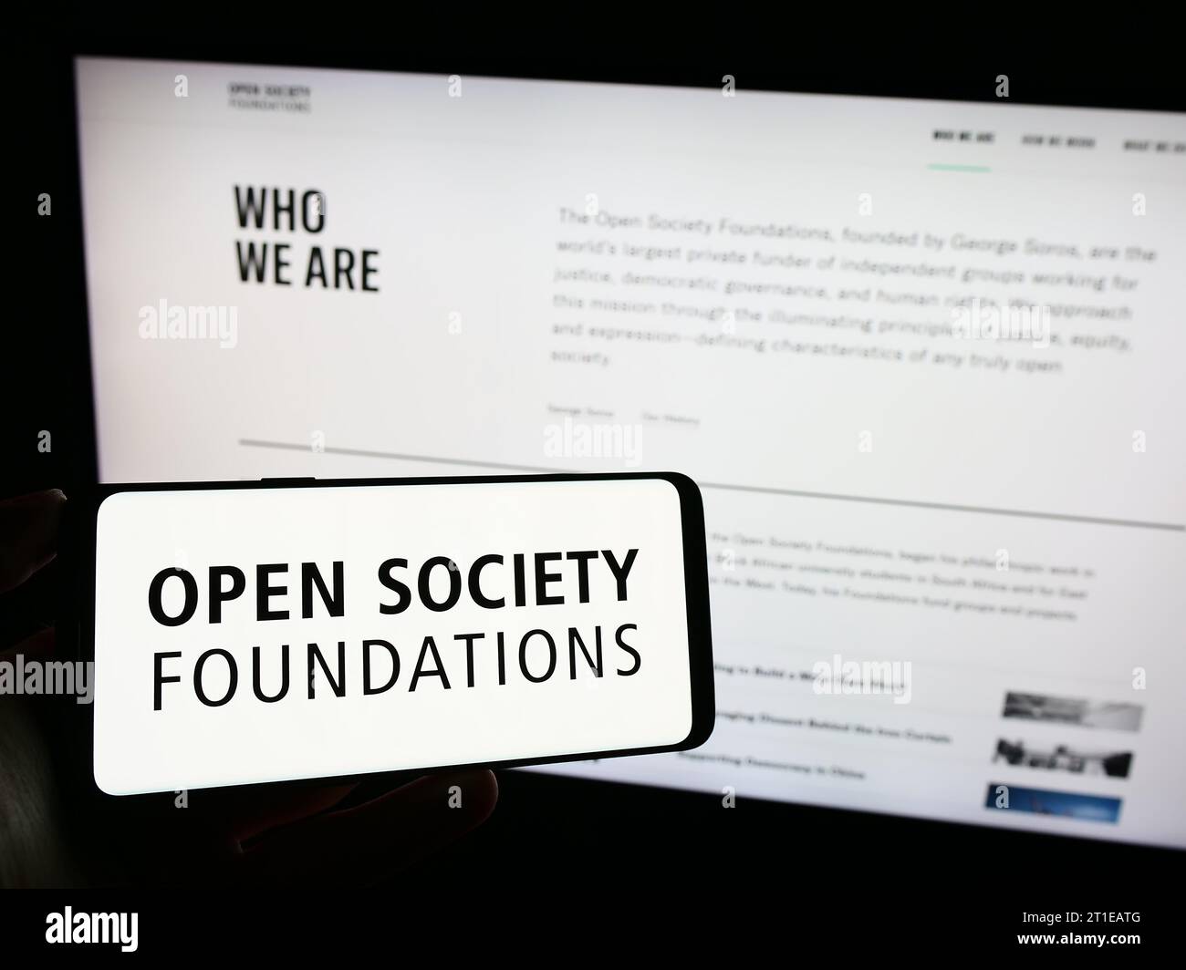 Person holding mobile phone with logo of organization Open Society ...