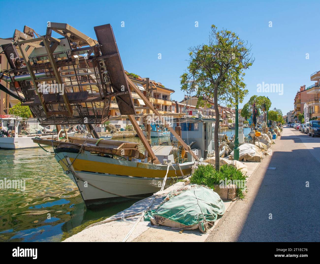 Fishing equipment and a trawler on the waterfront of Grado in Friuli ...