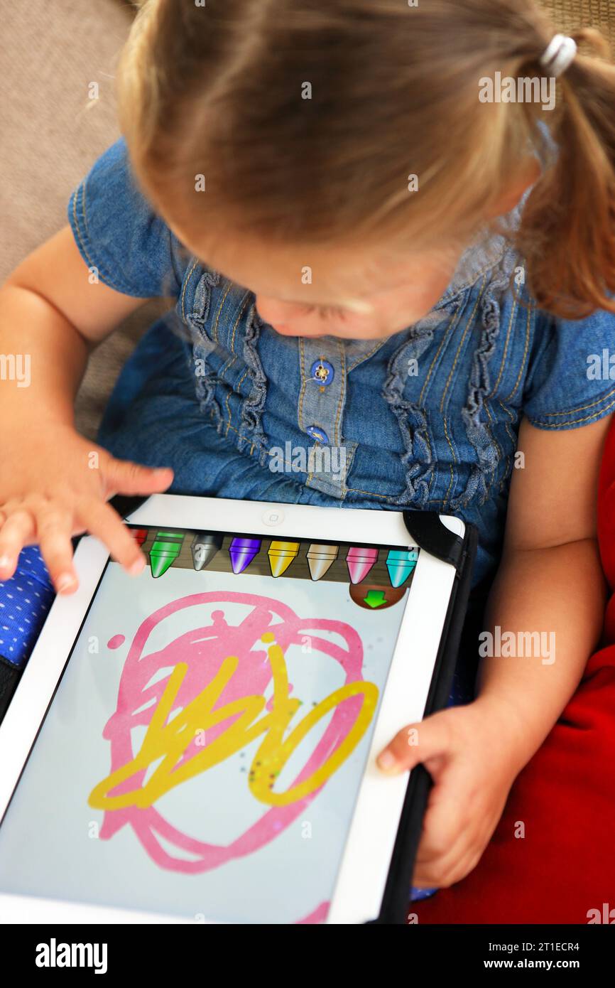 2 and a half year old girl learning to draw with an iPad Stock Photo ...