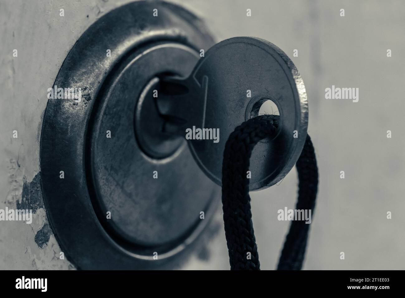 Closeup photograph of a door knob with an attached rope, taken from an ...