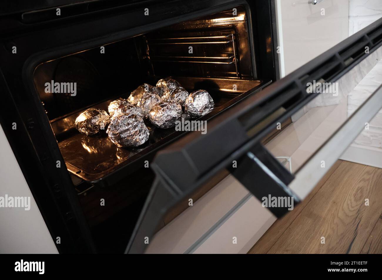 baking food in oven in modern interior Stock Photo - Alamy
