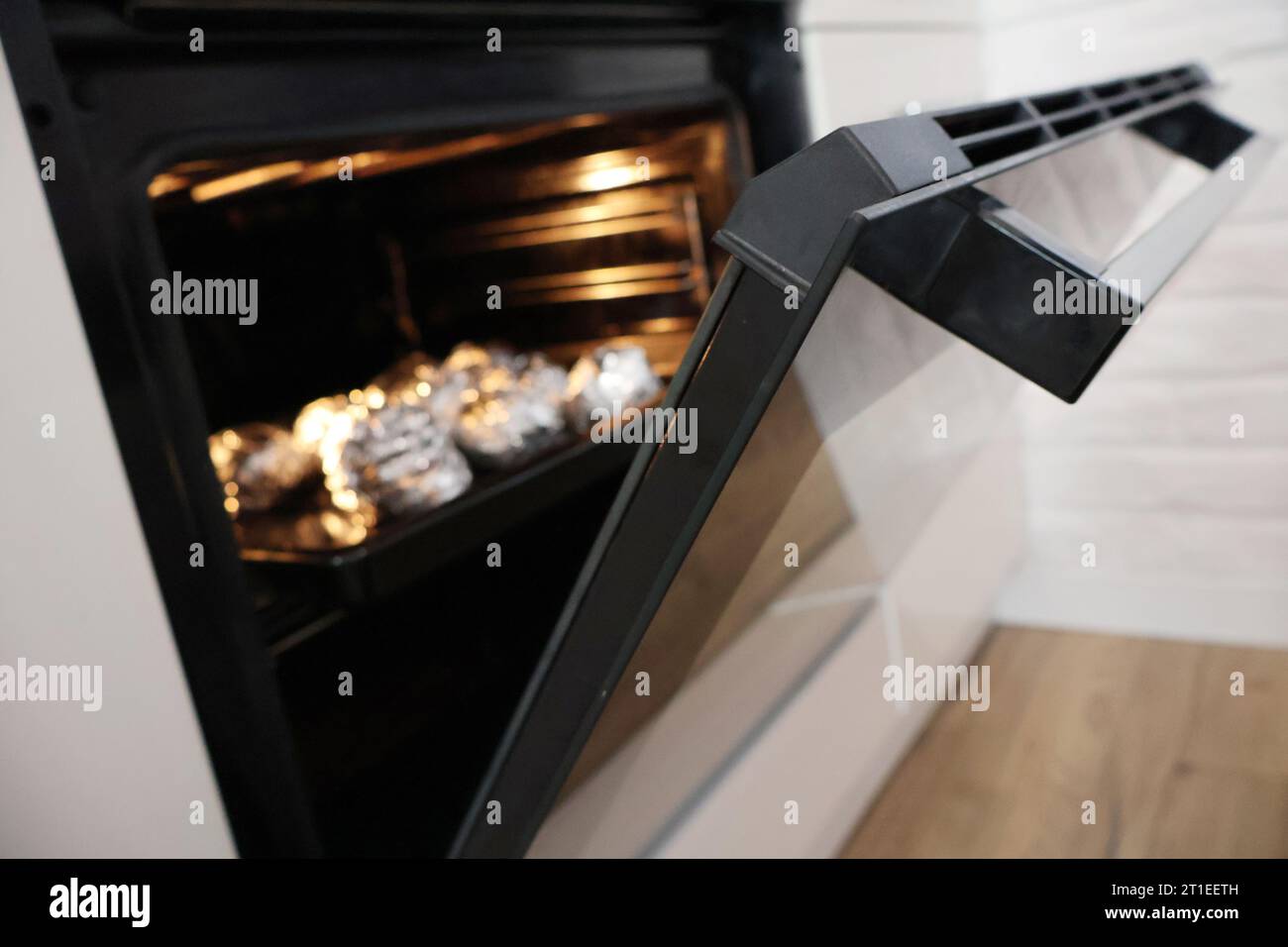 baking food in oven in modern interior Stock Photo - Alamy