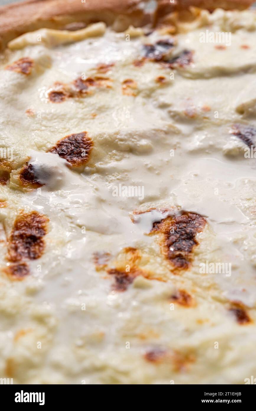 Thin pizza base with creamy cheese Stock Photo - Alamy