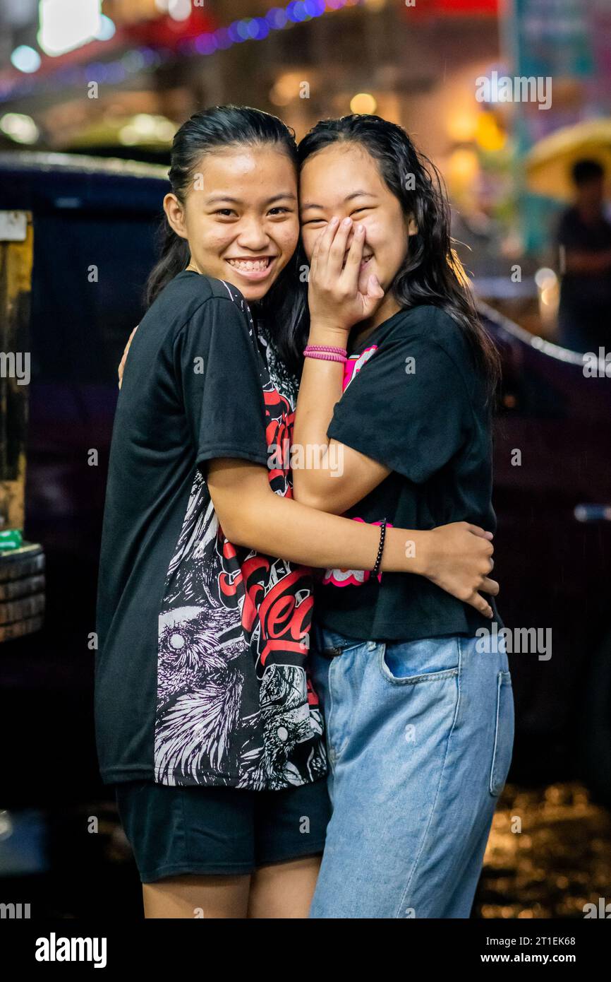 Two young pretty Filipino girls pose and smile for their portrait in ...