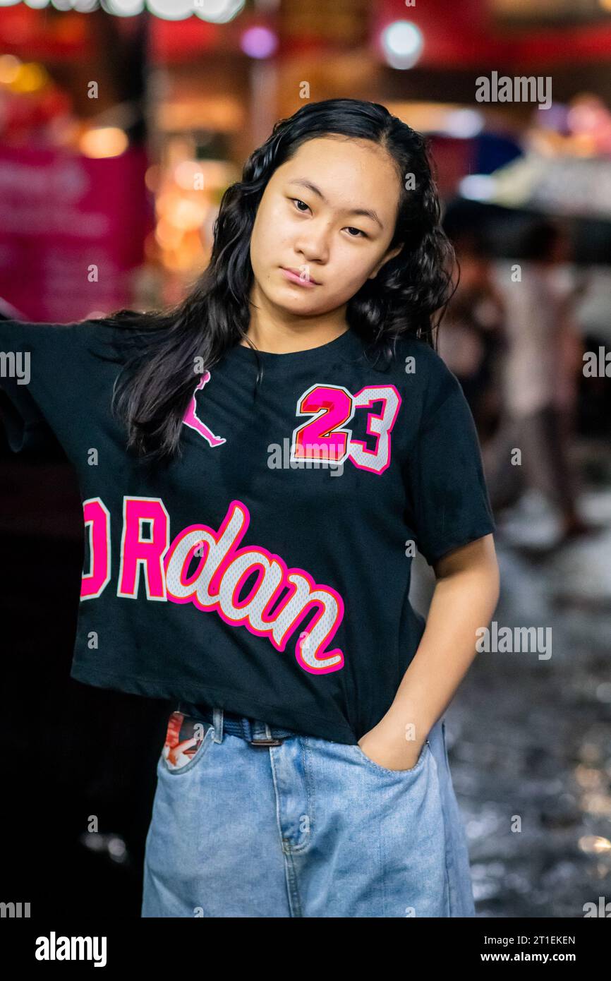A young pretty Filipino girl poses and smiles for her portrait in the ...