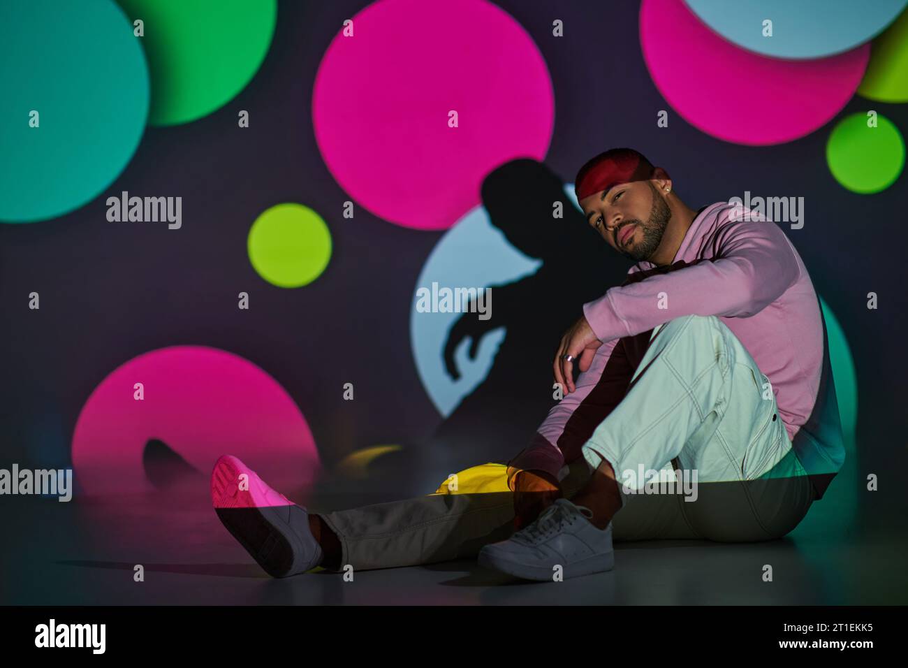 handsome young man sitting on floor slightly smiling in digital ...