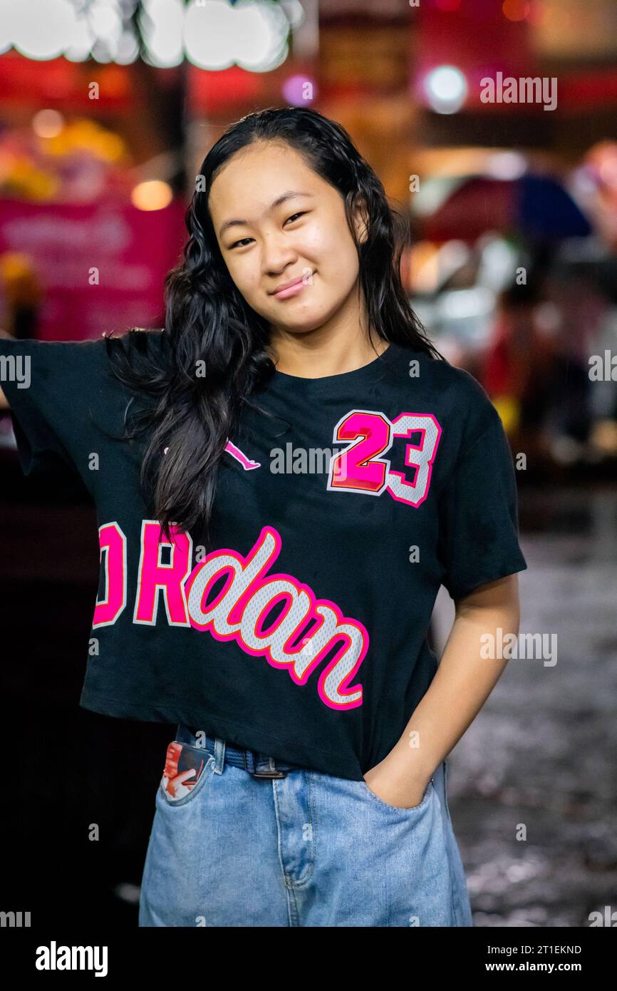 A young pretty Filipino girl poses and smiles for her portrait in the ...