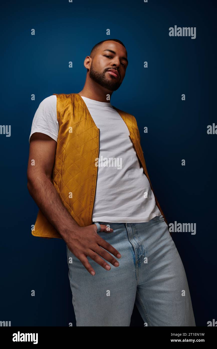 handsome african american male model in trendy outfit posing on dark ...