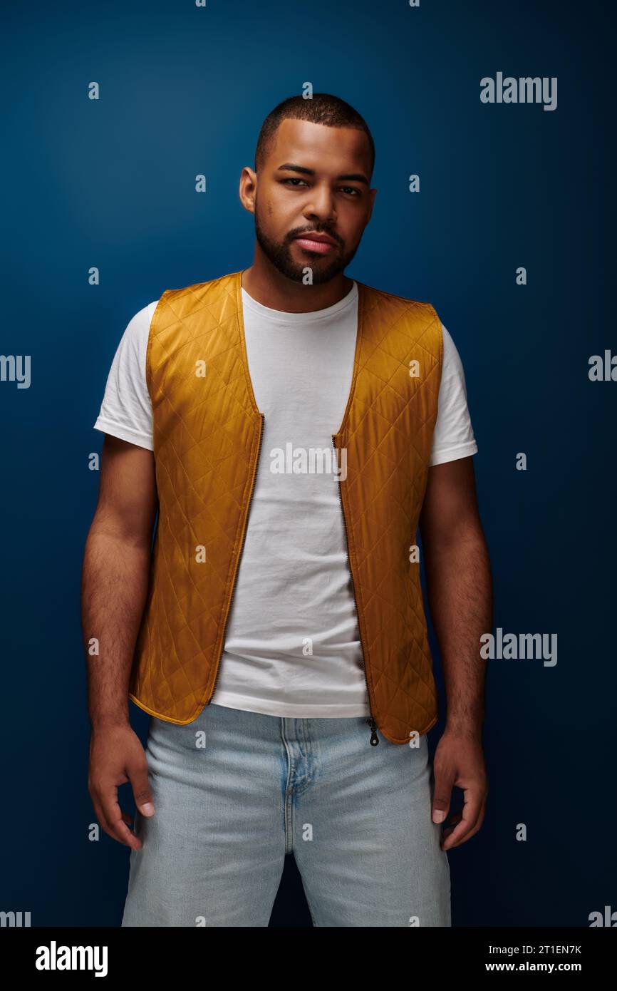 handsome bearded man standing still looking at camera on dark blue ...