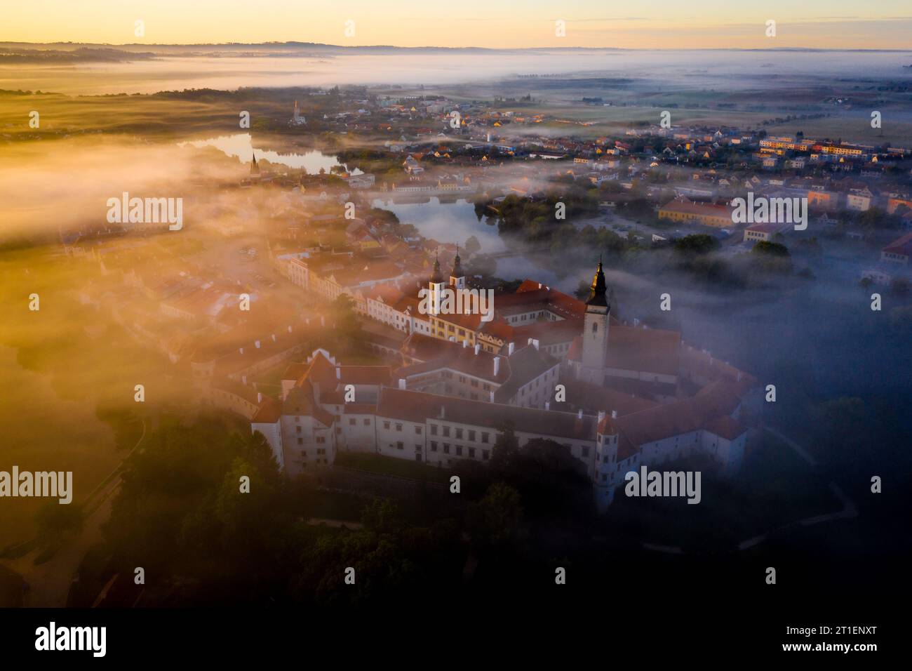 Aerial view of the historical centre of Telc on a foggy morning. In the ...