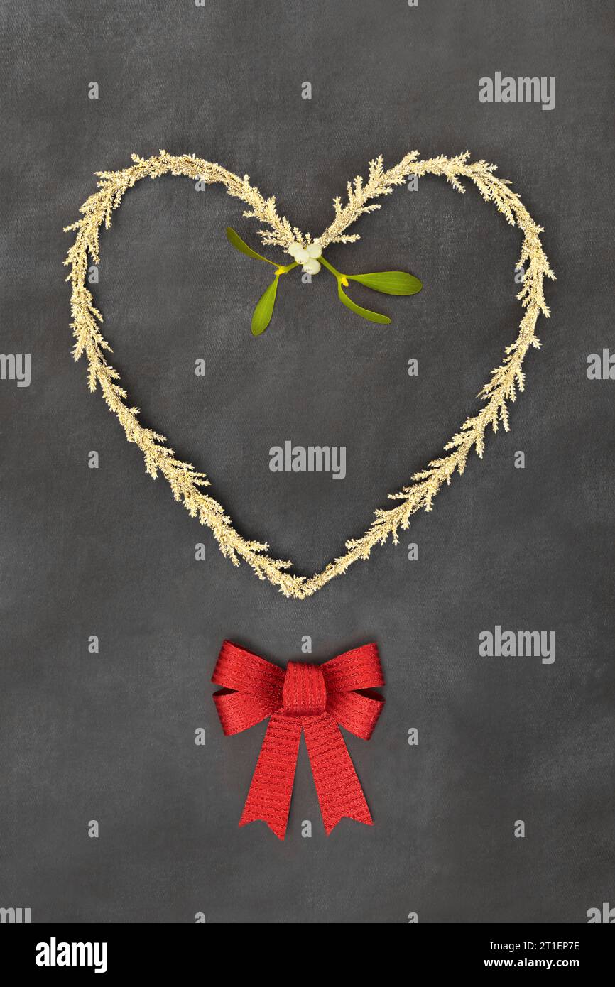 Christmas gold tinsel heart shape wreath, red bow, mistletoe sprig ...