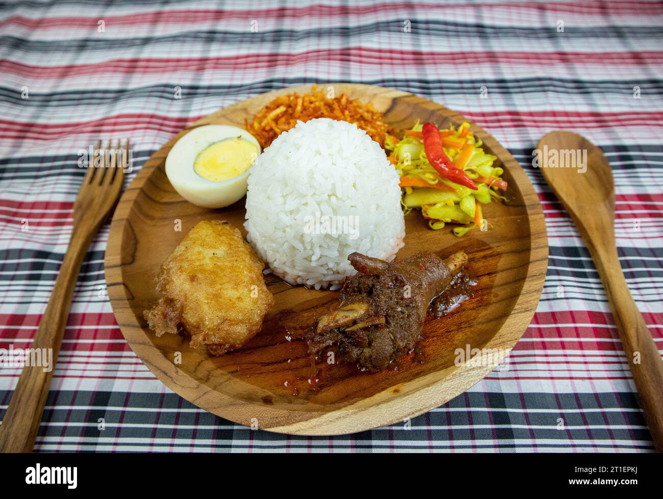 Red spiced chicken rice with pickled cucumber and carrots, boiled egg ...