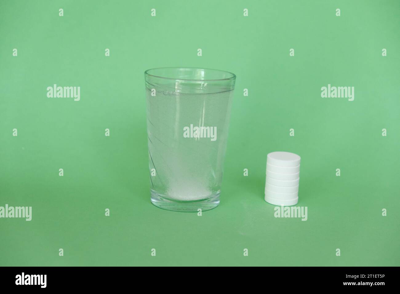 Water soluble C vitamin inside water with green background. Medical ...