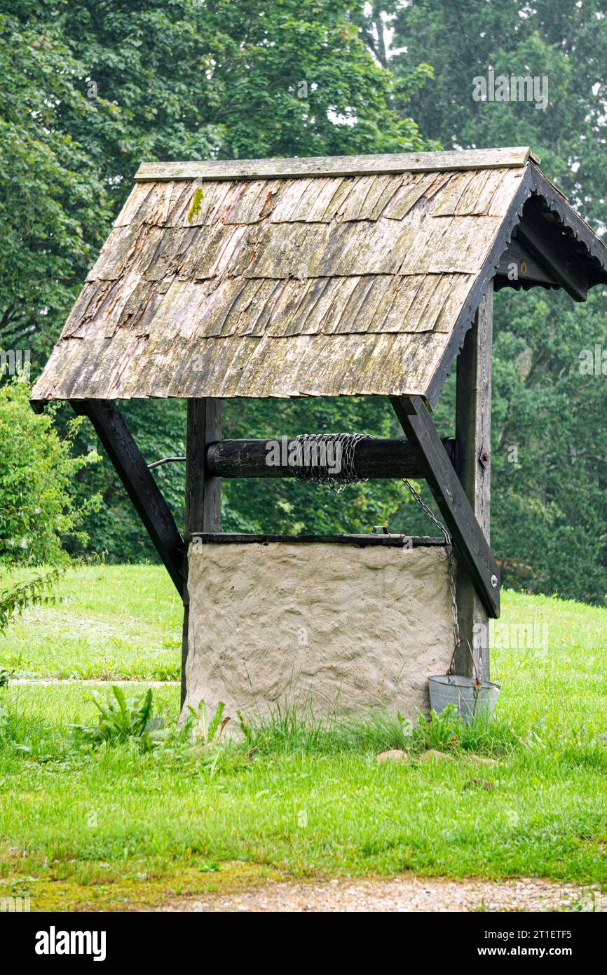 An old well with a shingled roof Stock Photo - Alamy