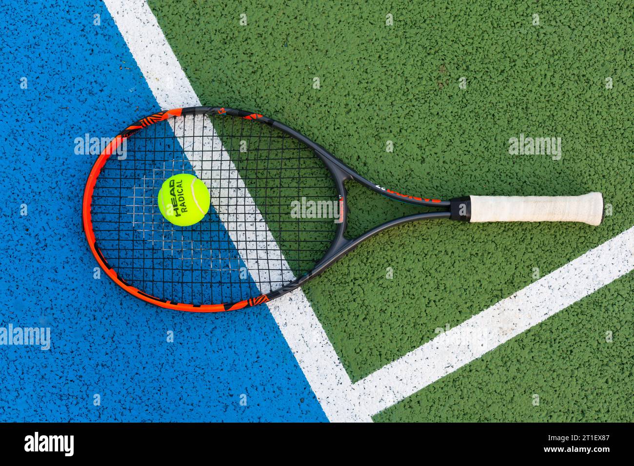 Head tennis racket with Head branded ball across line Stock Photo - Alamy