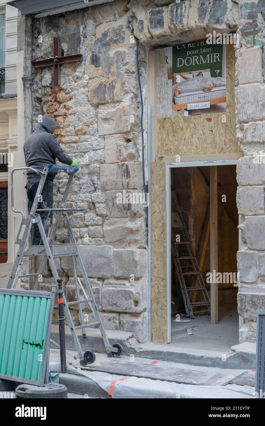 Paris France authentic daily life, worker renovating a store on a ...