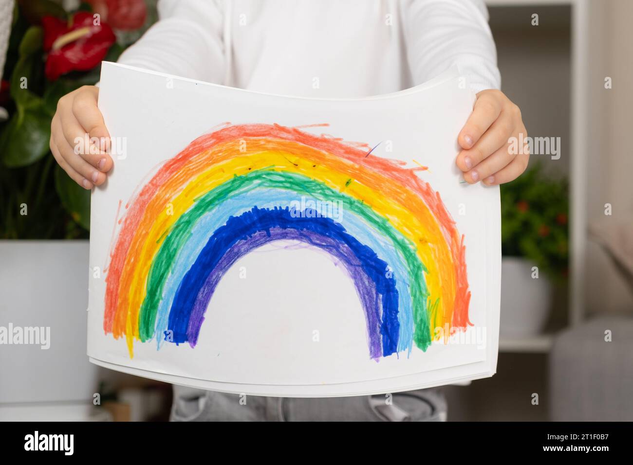 Little child showing his drawing of a rainbow in a sketchbook Stock ...