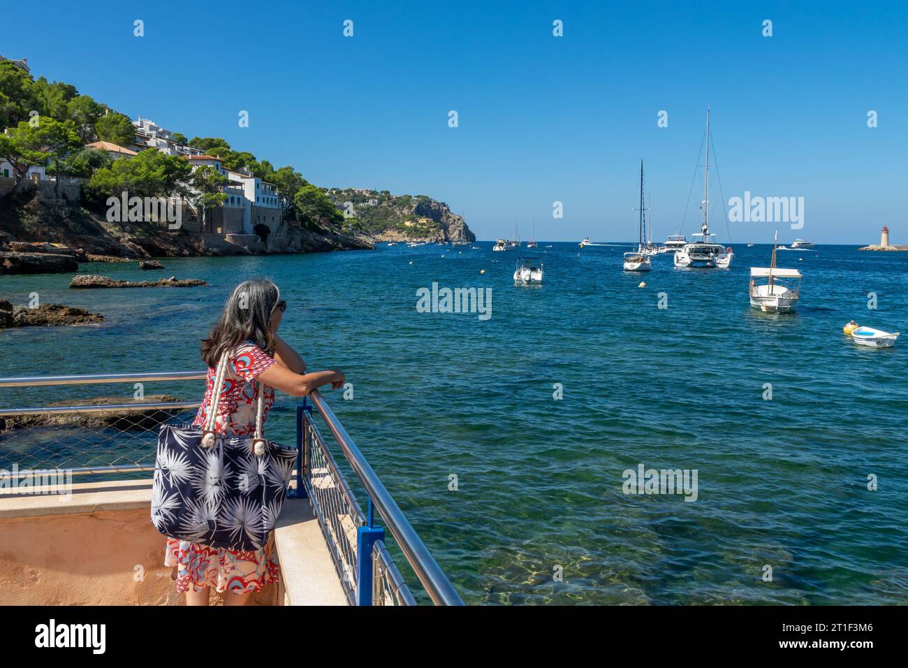 Brunette woman in her 50s admiring the views of Port d'Andratx on a ...