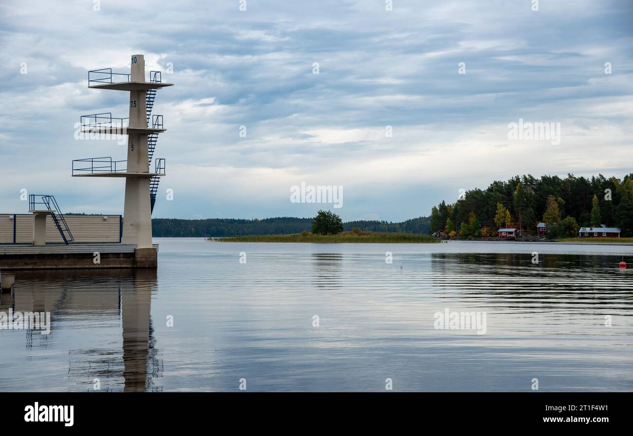 Diving board platform for dive in the lake. Cloudy sky copy space for ...