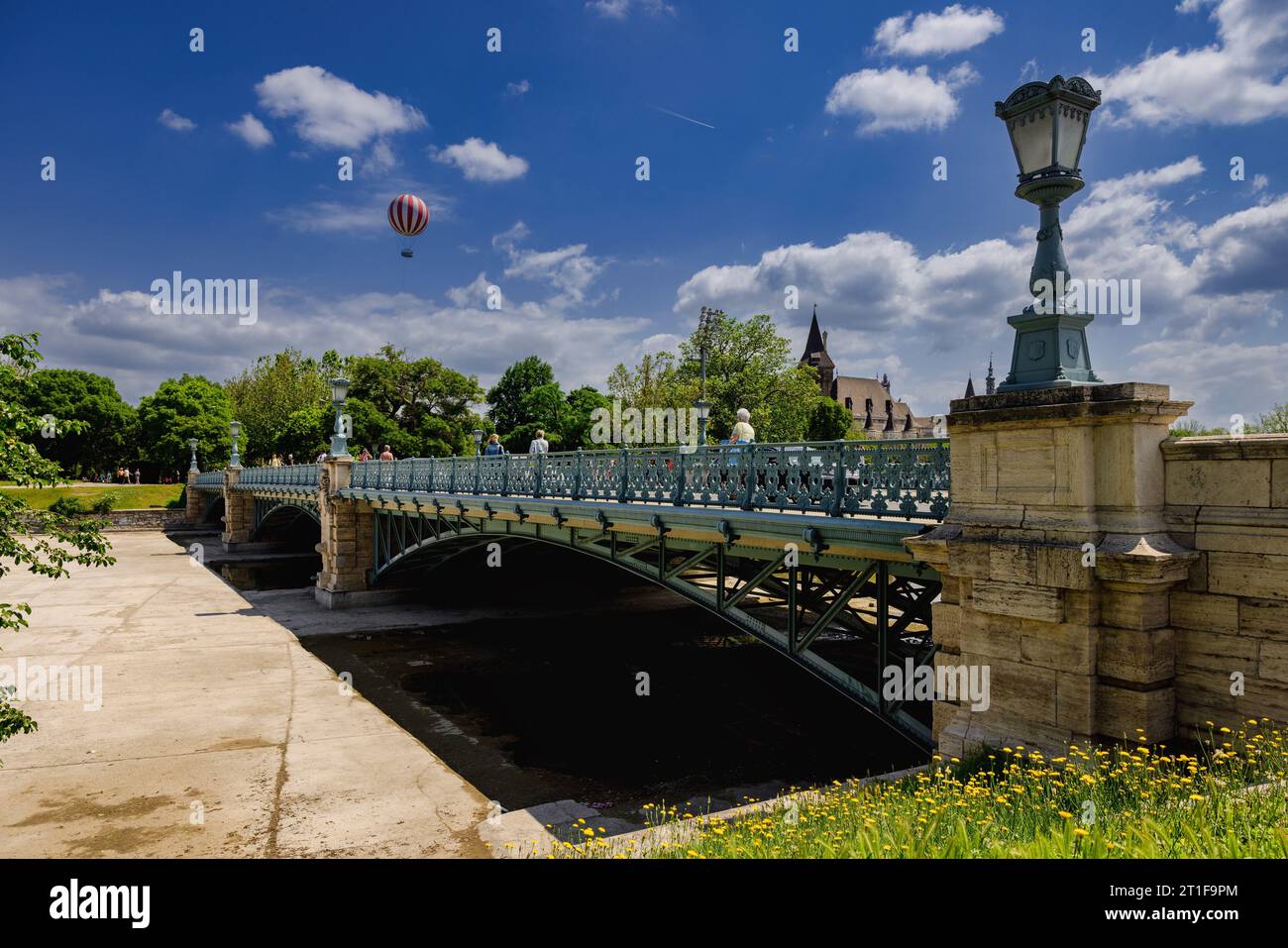 A picturesque scene featuring a large bridge arching over a river, with ...