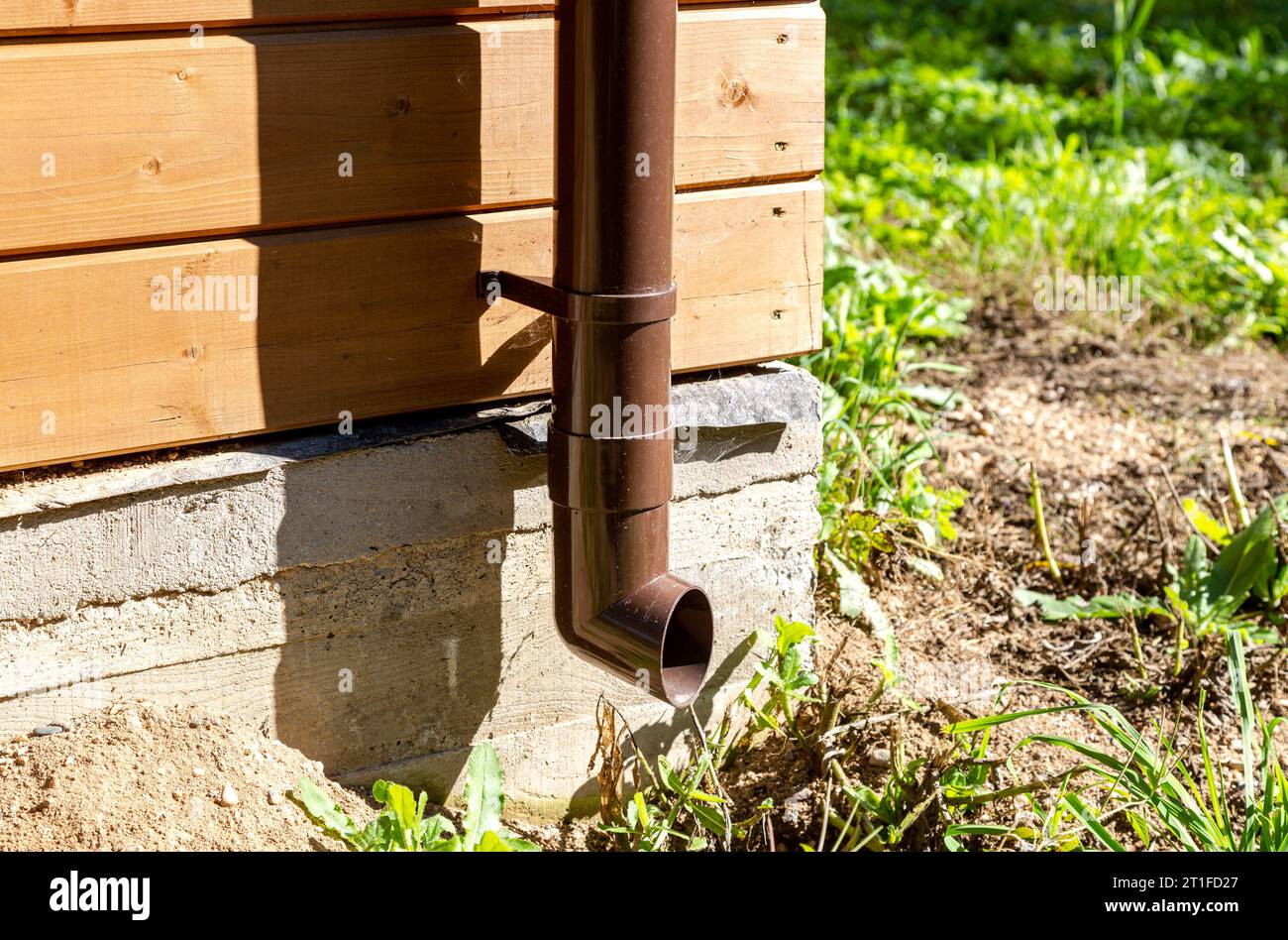 The new plastic rainwater drain pipe on a wooden house close up Stock ...