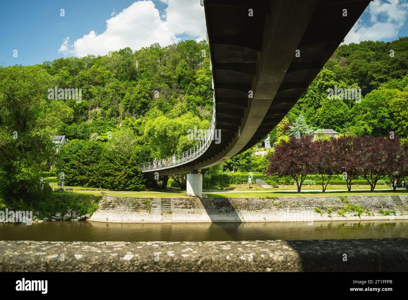 Pedestrian bridge over rocky stream near the small town of Durbuy in ...