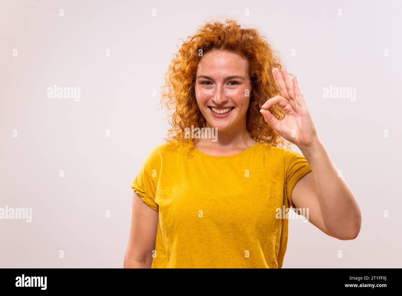 Happy woman showing winning sign hi-res stock photography and images ...