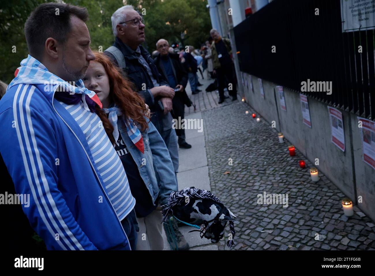 Berlin, Germany. 13th Oct, 2023. People take part in a vigil as a symbolic action in front of ...